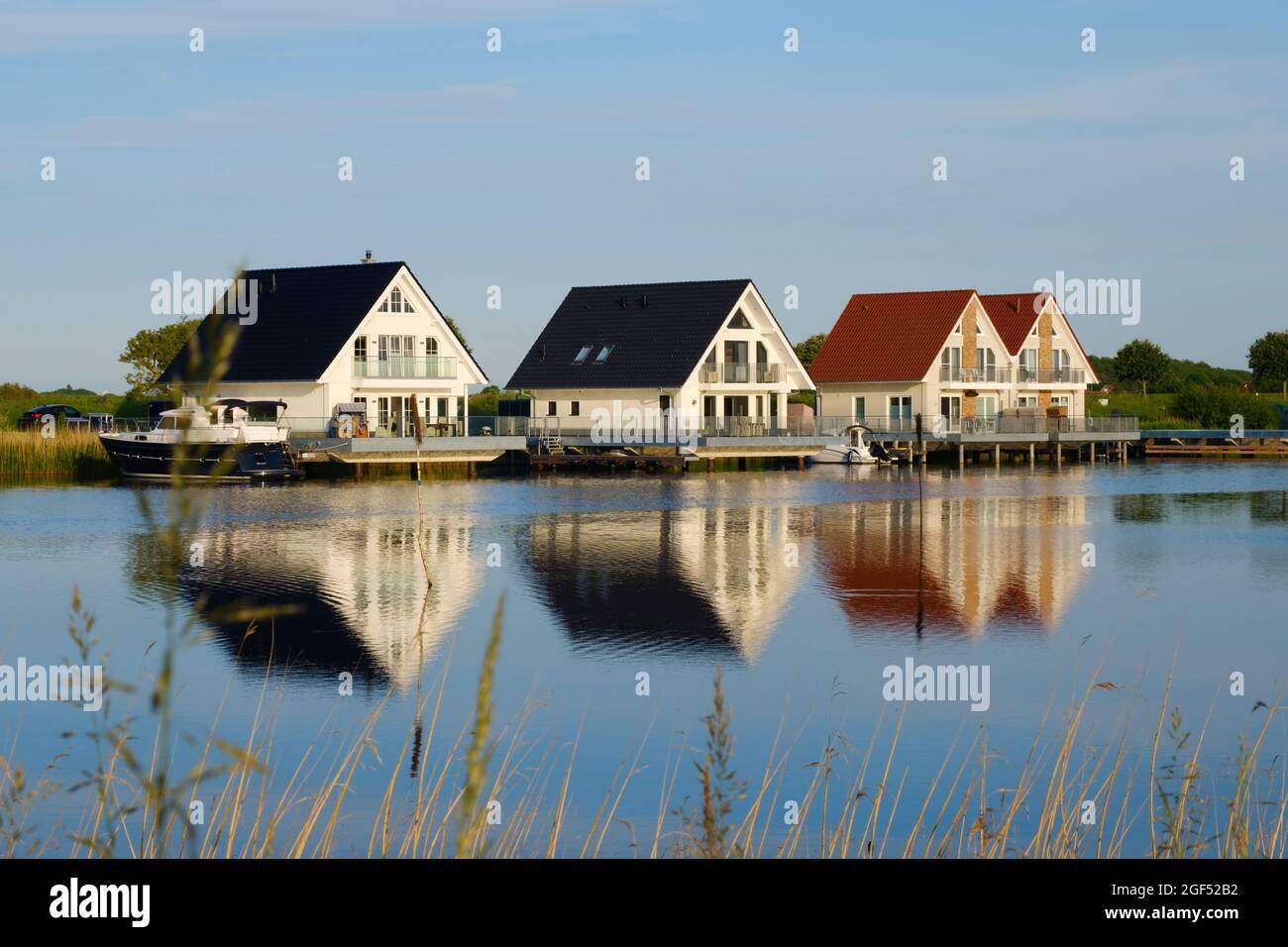 Germany, Lower Saxony, Harlesiel, Stilt houses on Harle river Stock ...