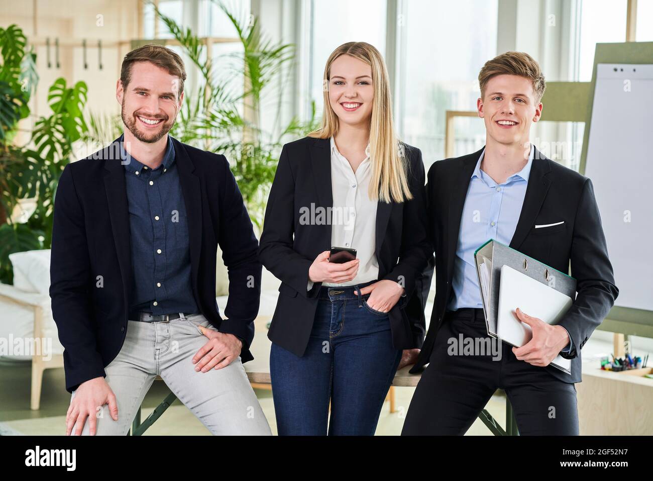 Smiling male and female professionals together in office Stock Photo ...