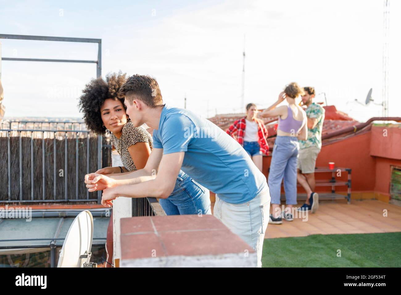 Couple of friends talking at party hi-res stock photography and images ...
