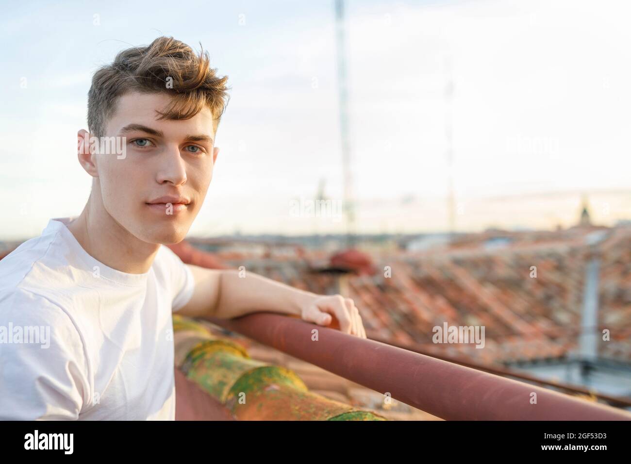 Young man leaning railing hi-res stock photography and images - Alamy