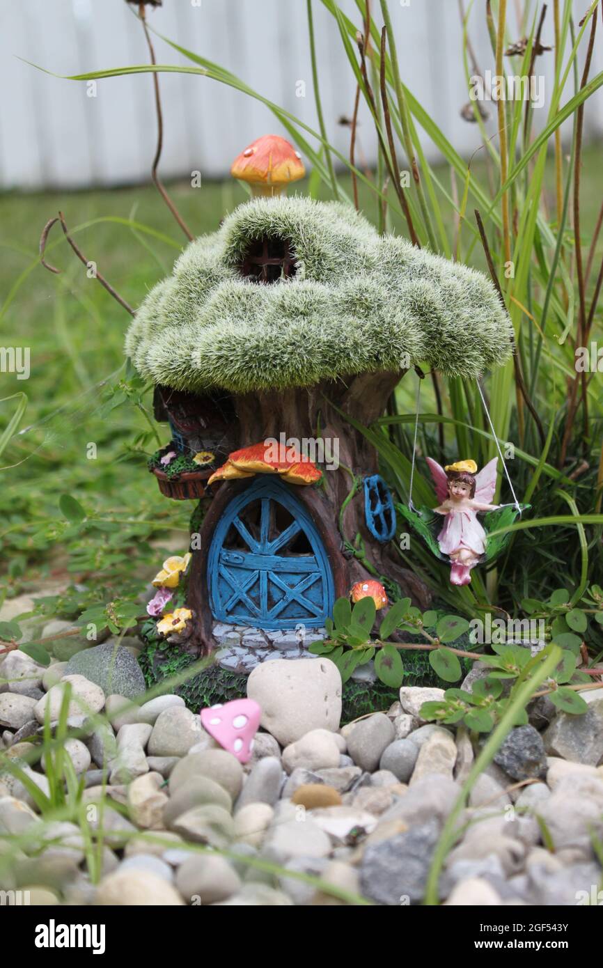Fairy garden house in overgrown rock garden Stock Photo - Alamy