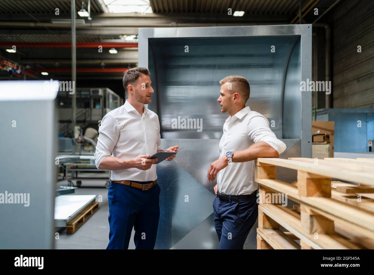 Male inspectors having discussion while standing in industry Stock ...