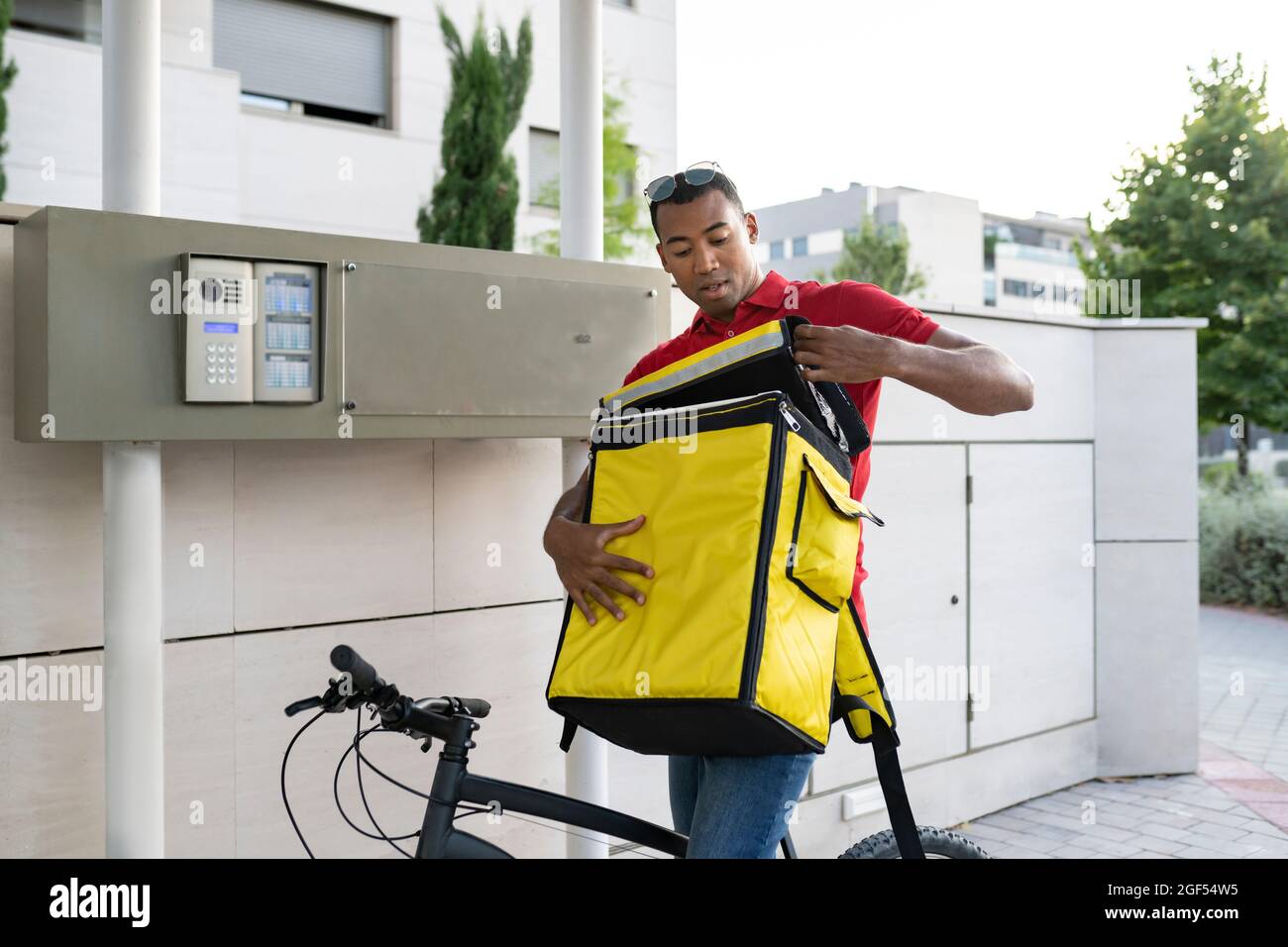 Delivery man with yellow backpack hi-res stock photography and images ...