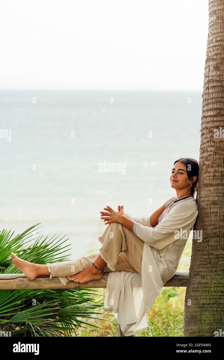 Woman sitting railing hi-res stock photography and images - Alamy