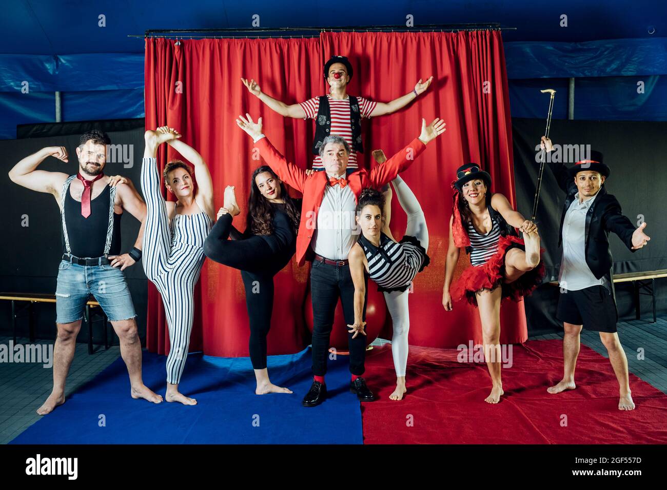 Acrobats team stretching while standing on stage in circus Stock Photo ...