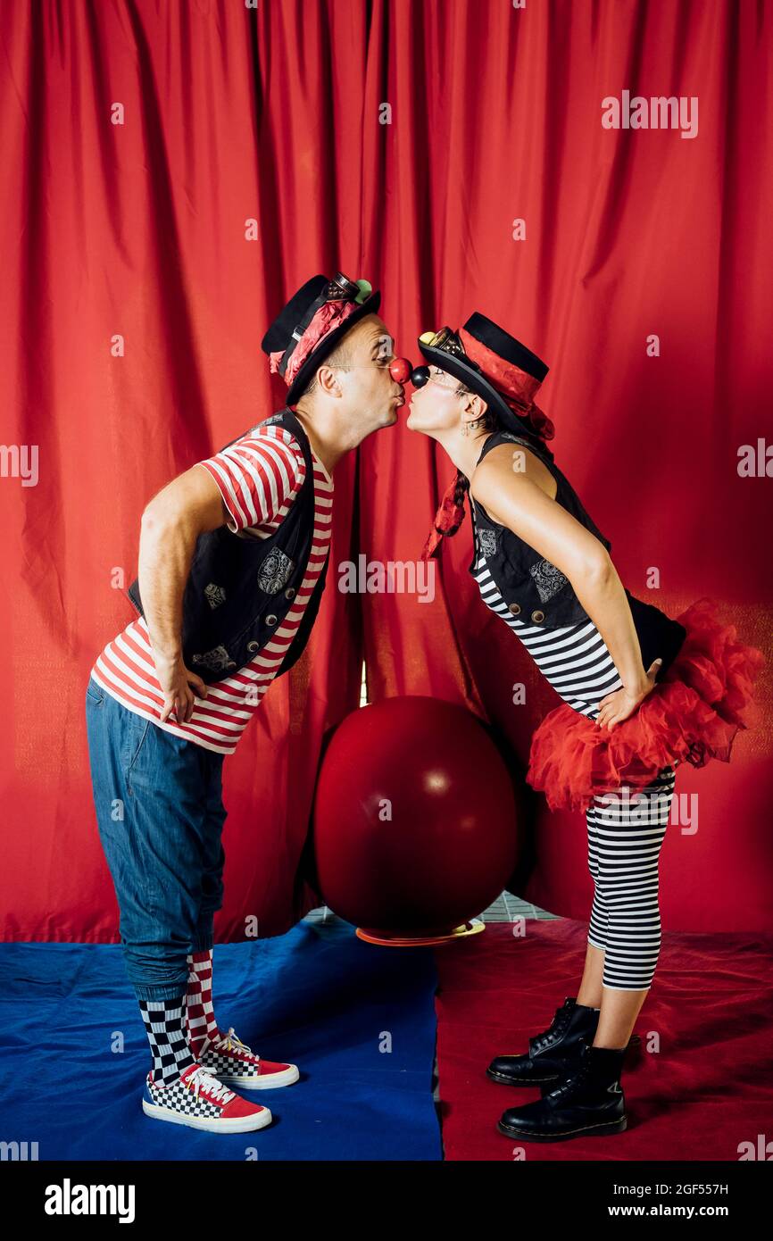 Circus performer kissing each other while standing on stage Stock Photo ...