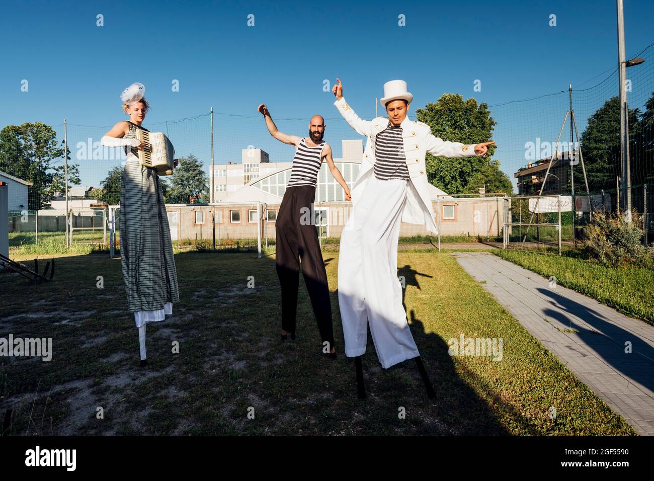 Male and female artists dancing while standing on stilts Stock Photo ...