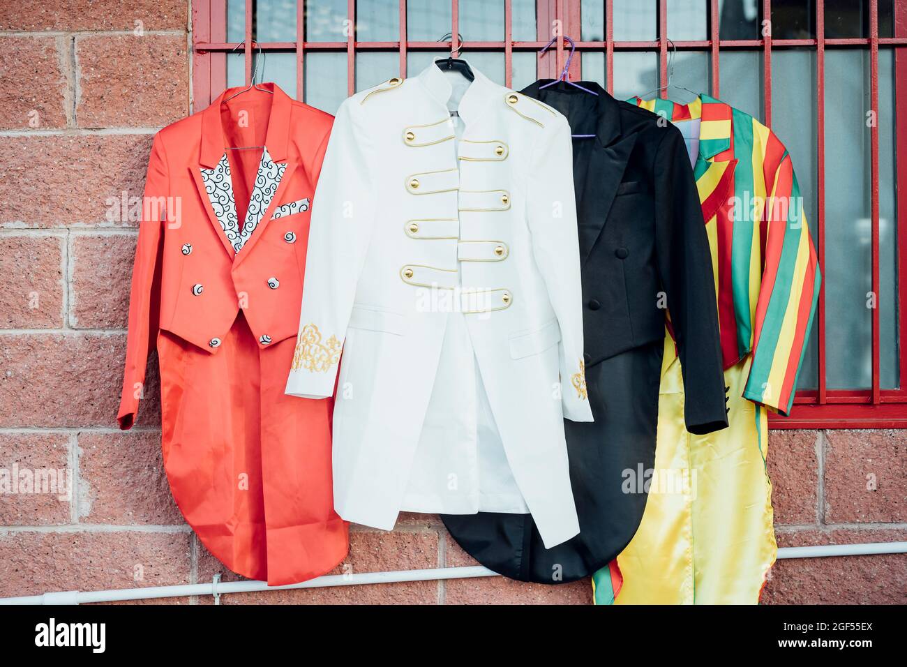 Costumes hanging on window Stock Photo - Alamy