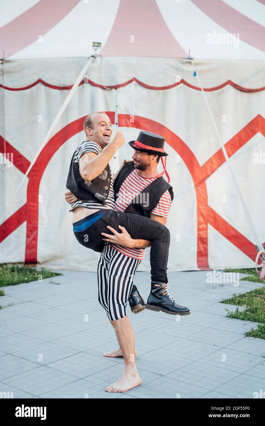 Male acrobats having fun while standing on footpath Stock Photo - Alamy