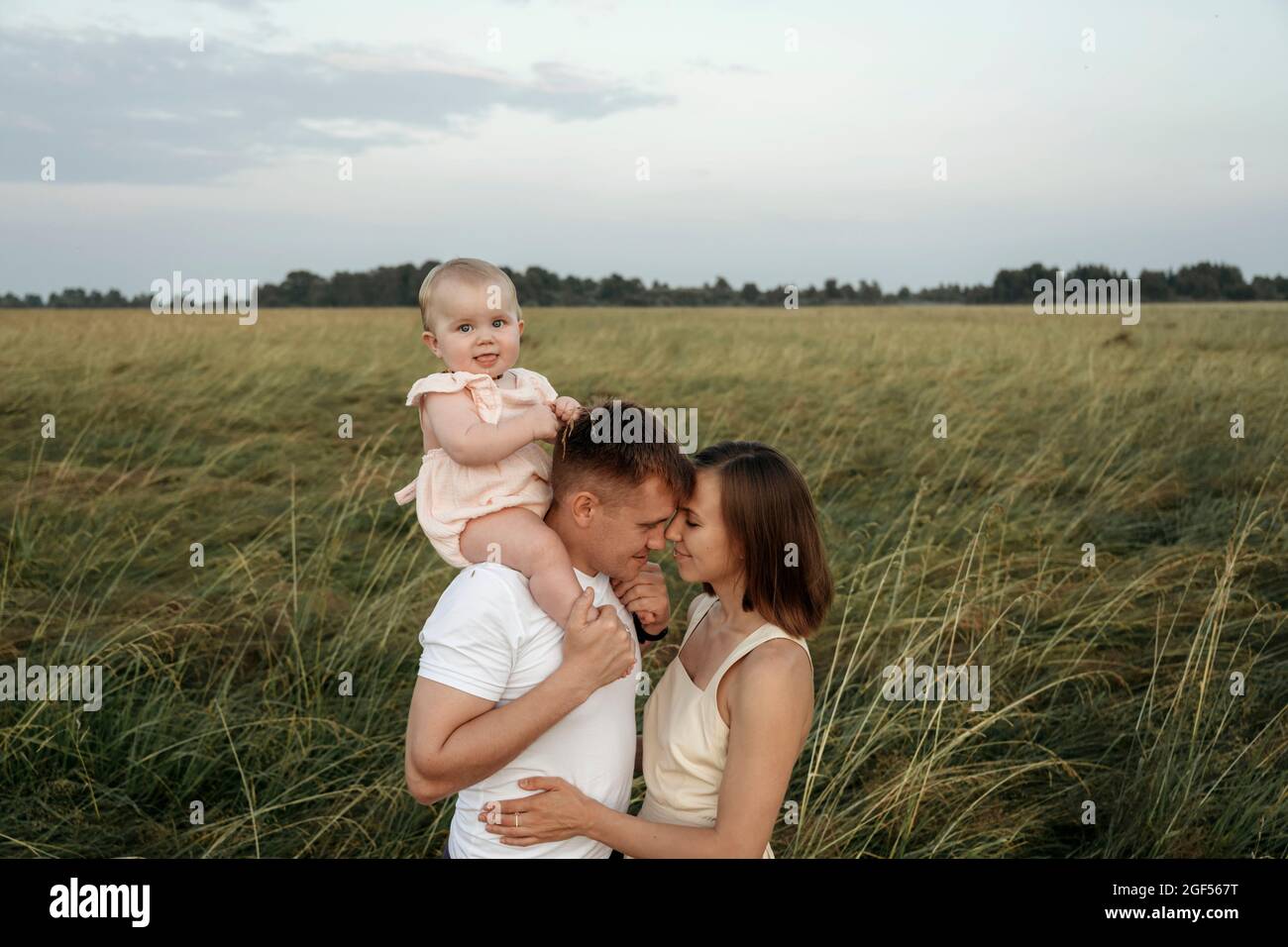 Parents embracing daughter hi-res stock photography and images - Alamy