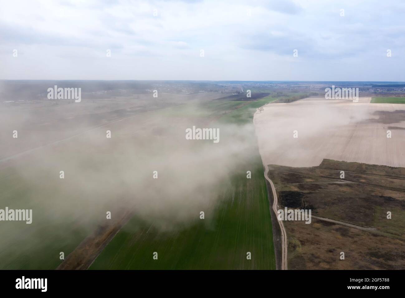 Dust storm on an agricultural field. Wind erosion of agricultural soils ...