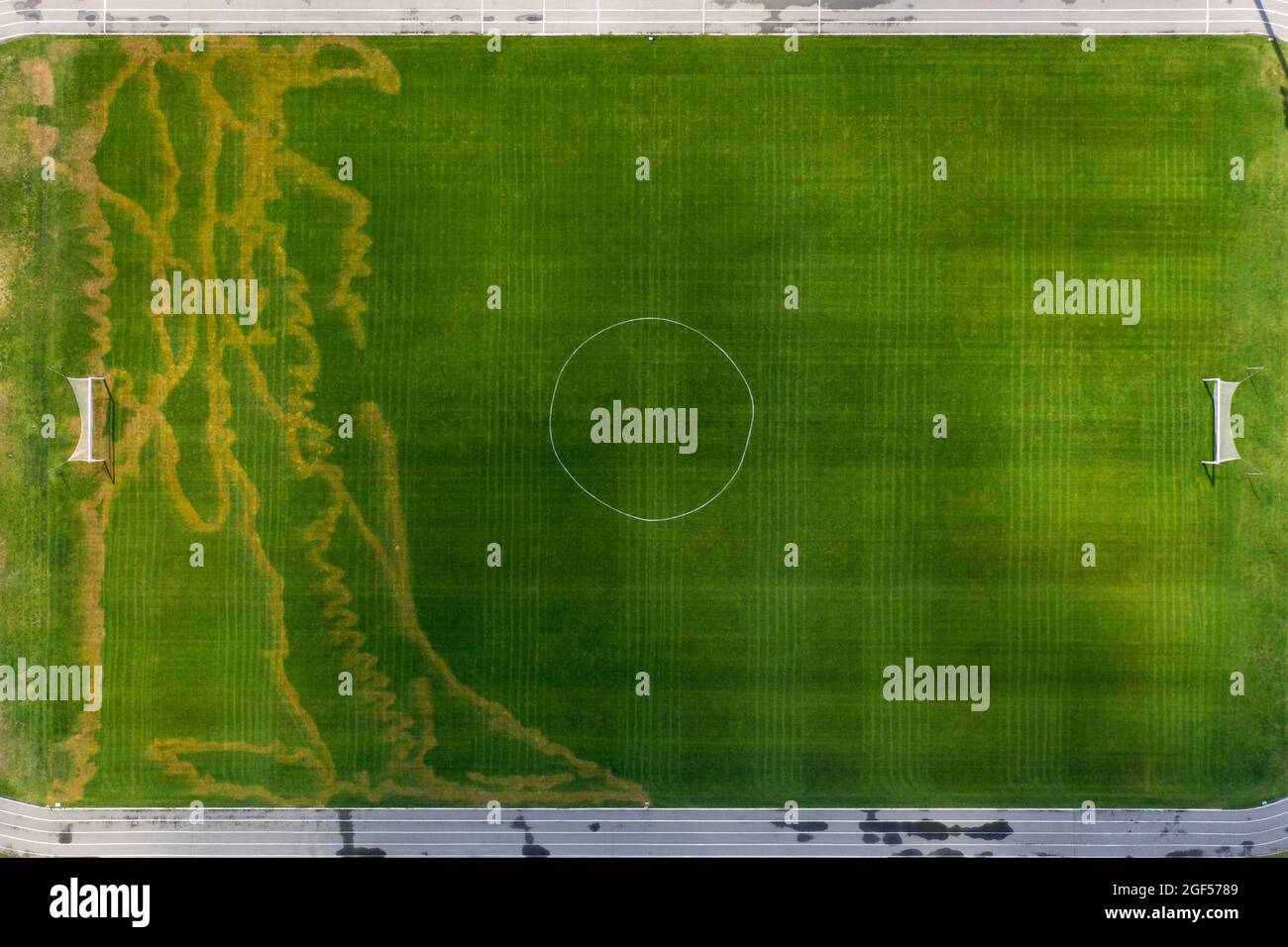 Damaged lawn grass on the football field. View from the drone ...
