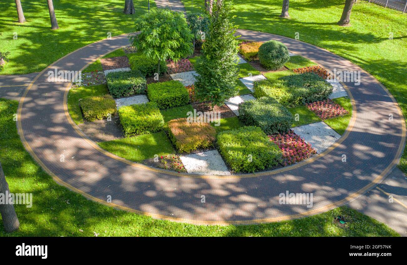 Topiary flower bed with trees and shrubs trimmed into geometric shapes ...