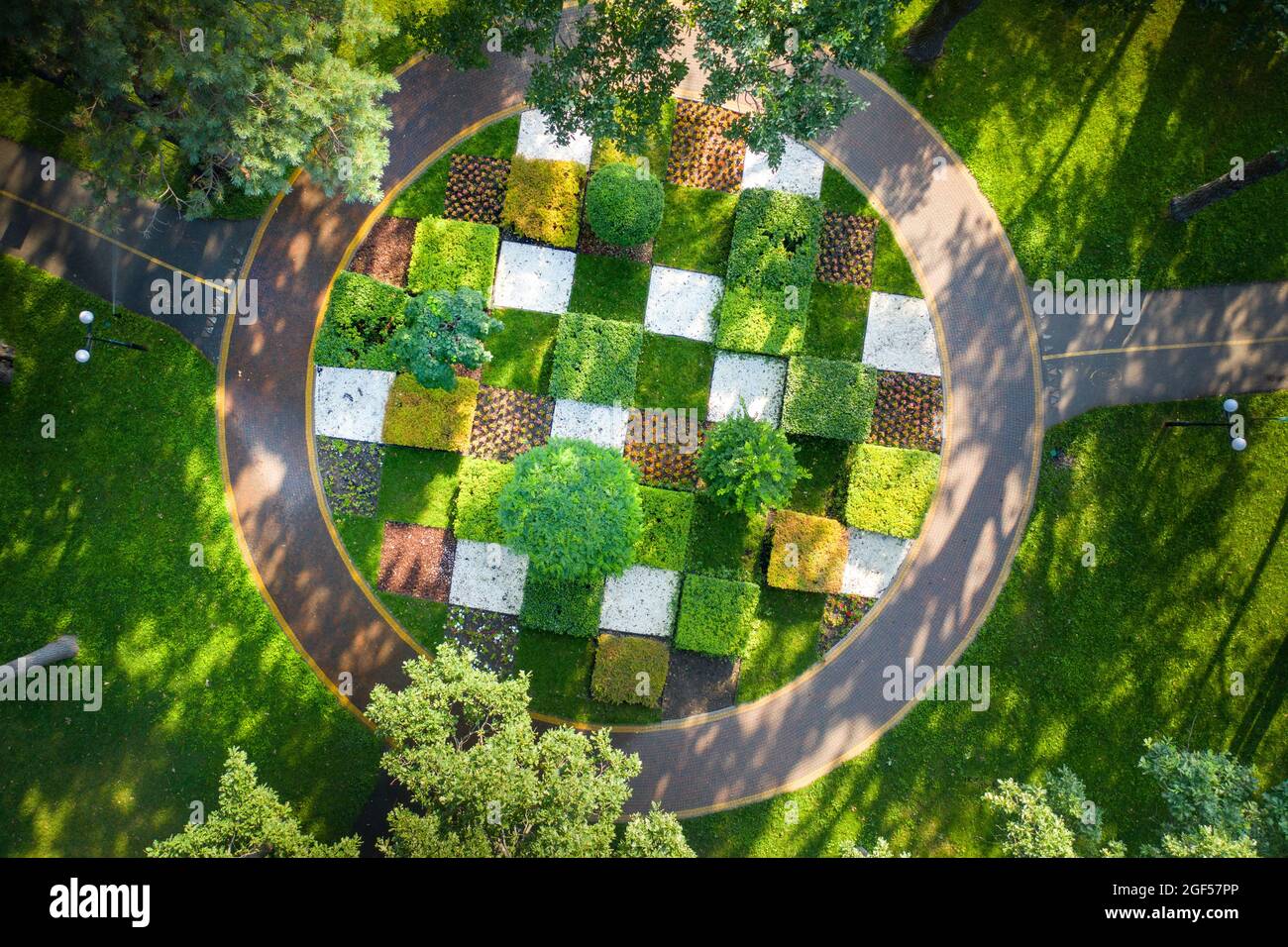 Topiary flower bed with trees and shrubs trimmed into geometric shapes ...