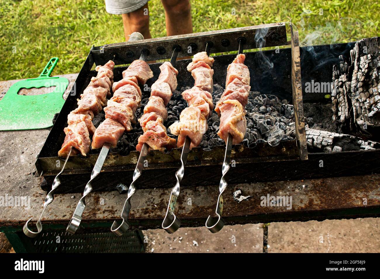 Shish kebab on skewers outdoors close-up. Electric brazier with ...