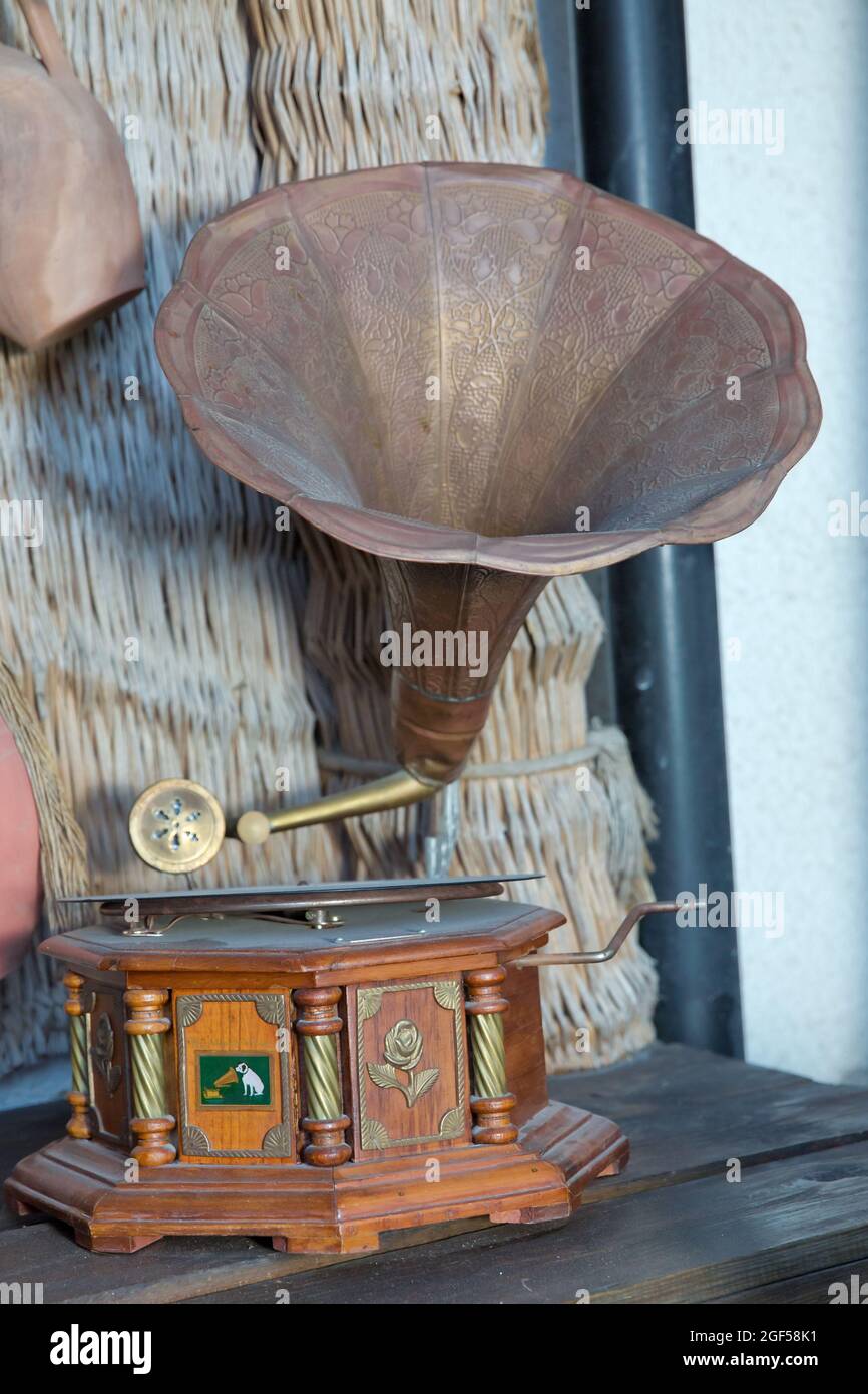 Old record player against ancient wooden wall. Antique gramophone with ...