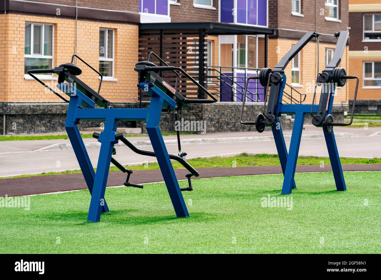 public weight machines outdoors in the yard of a modern residential ...