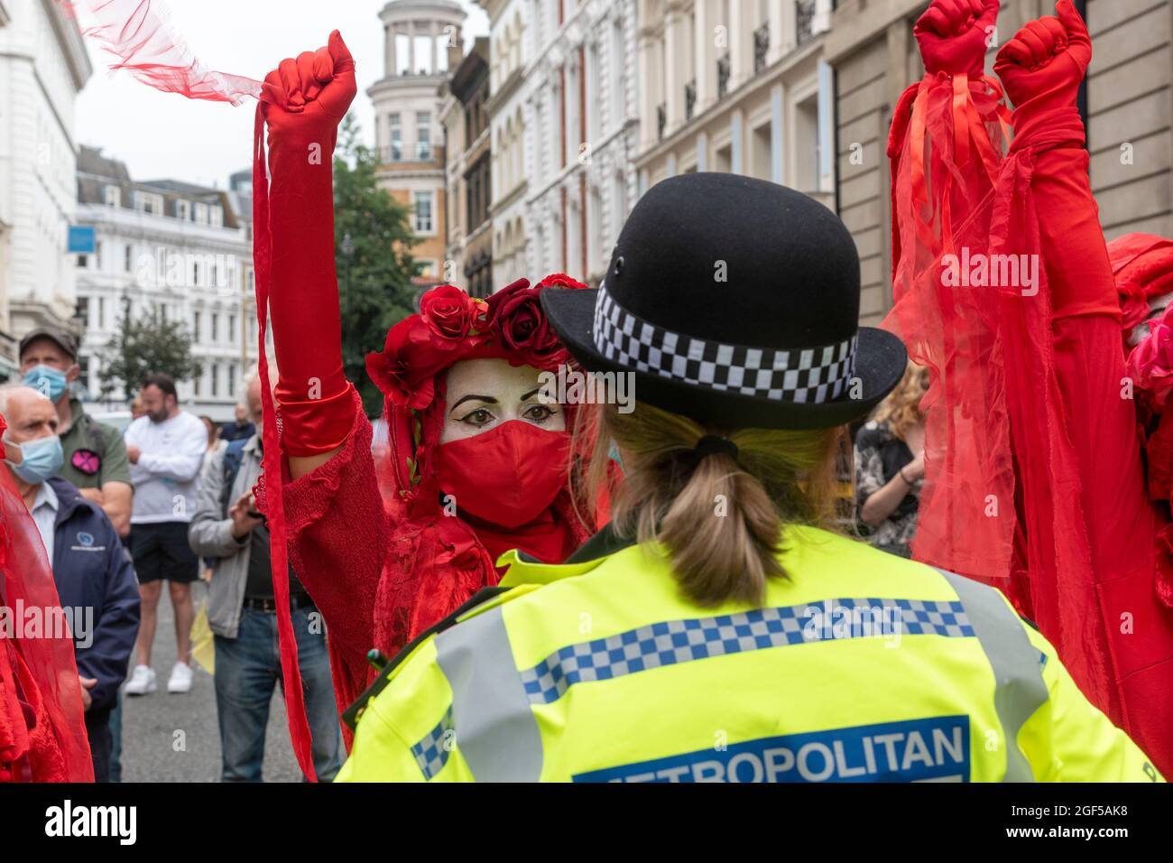 London, UK. 23rd Aug, 2021. A member of the Extinction Rebellion Red ...