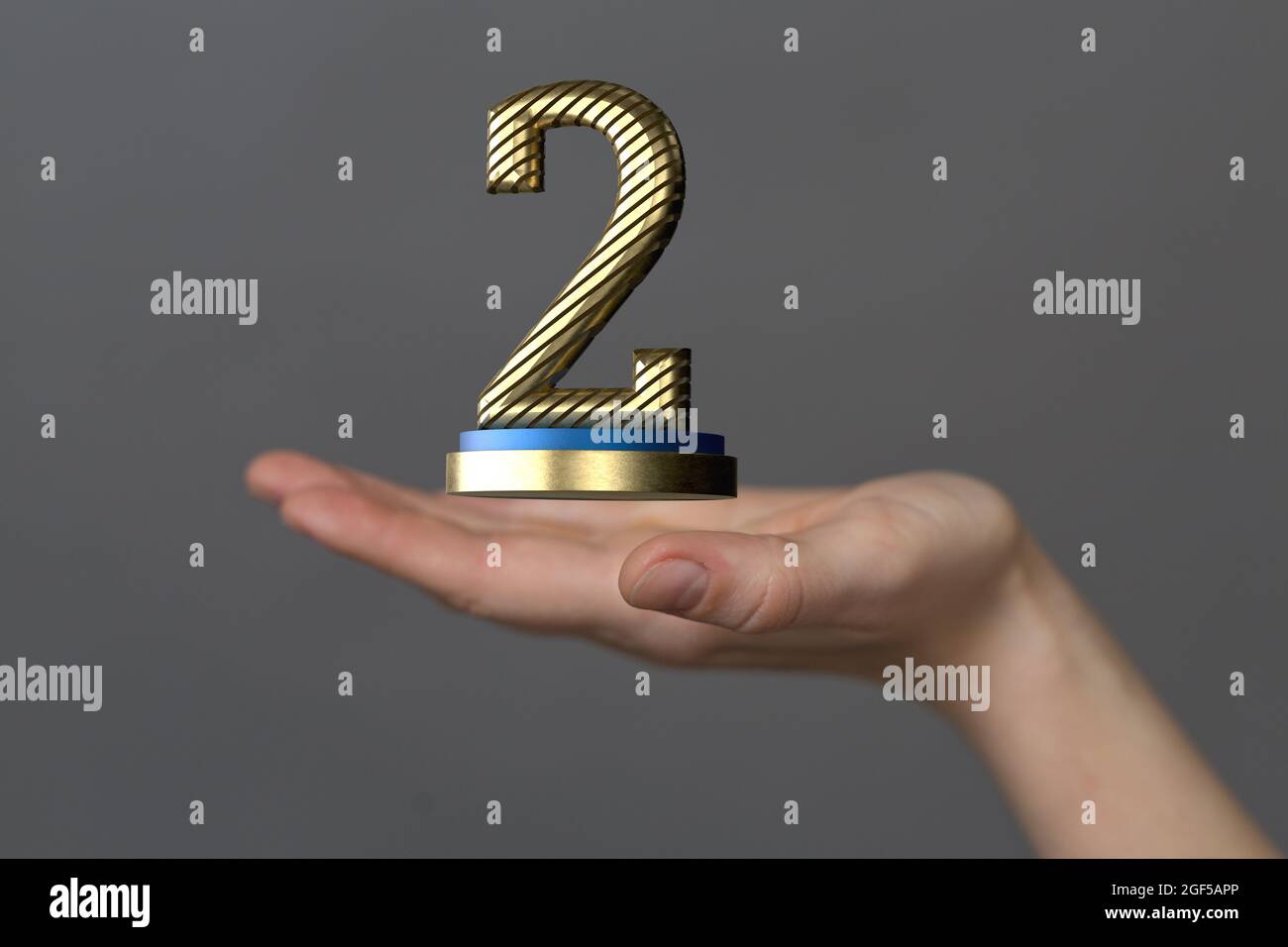 Person presenting a 3D render of the 2nd place award or 2-year ...