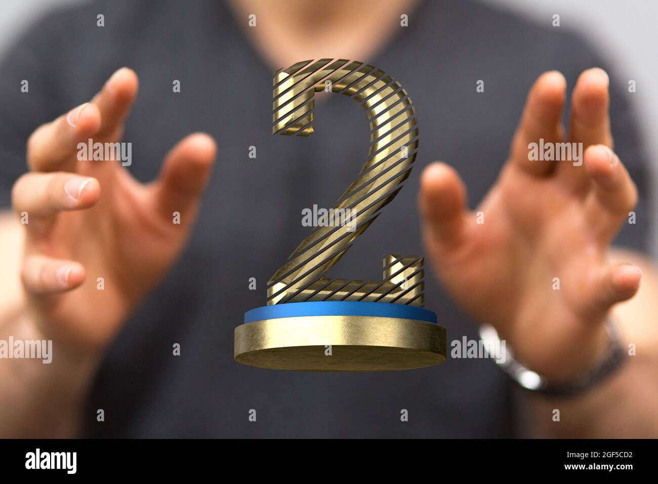Man holding the 3D second place prize trophy Stock Photo - Alamy