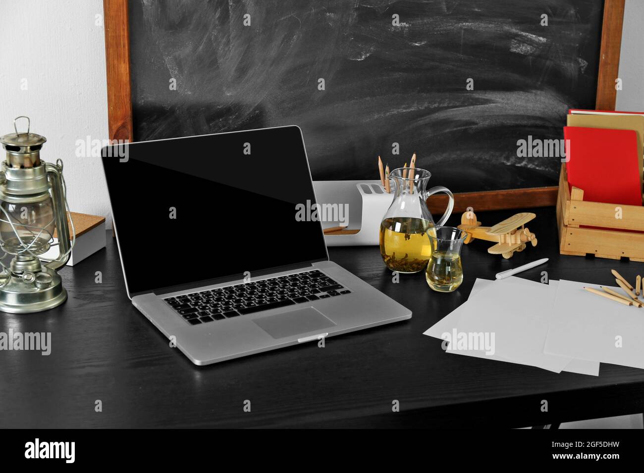Desktop with notebook and other items on blackboard background Stock ...