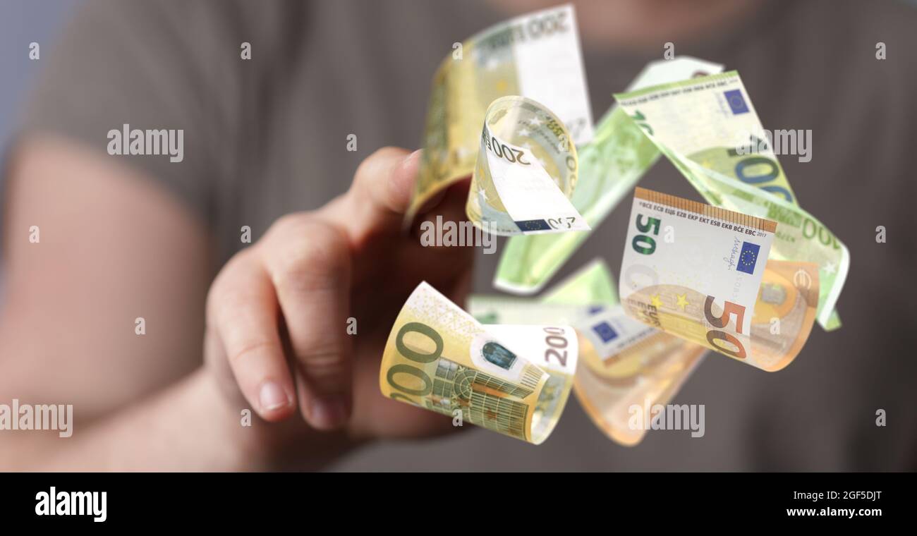 Falling euro banknotes presented by a person Stock Photo - Alamy