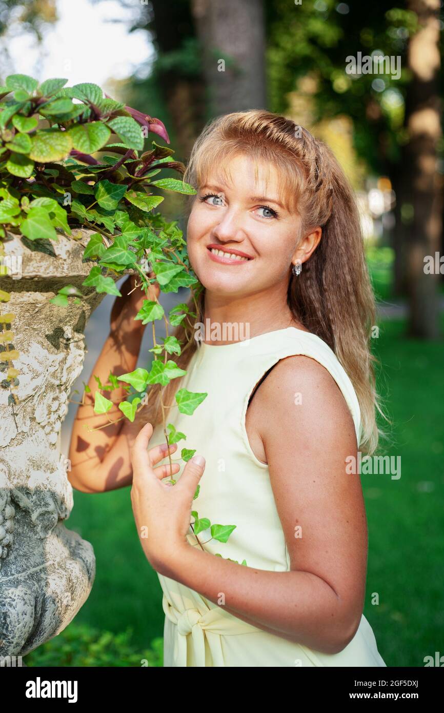 Happy woman in summer park in short dress Stock Photo - Alamy