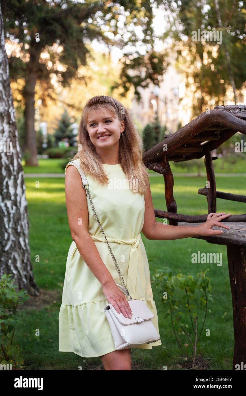 Happy woman in summer park in short dress Stock Photo - Alamy