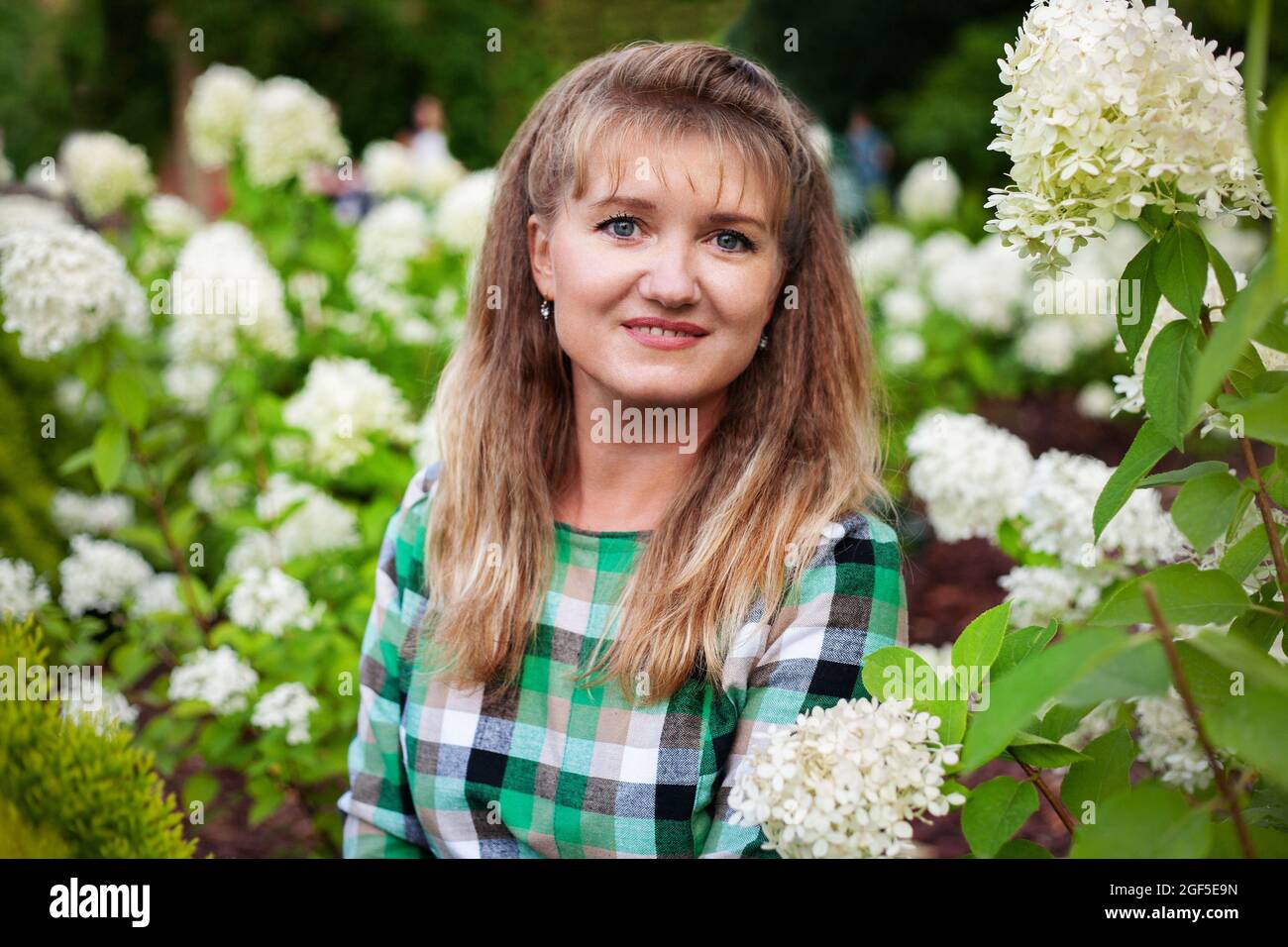 Happy woman in summer park in short dress Stock Photo - Alamy