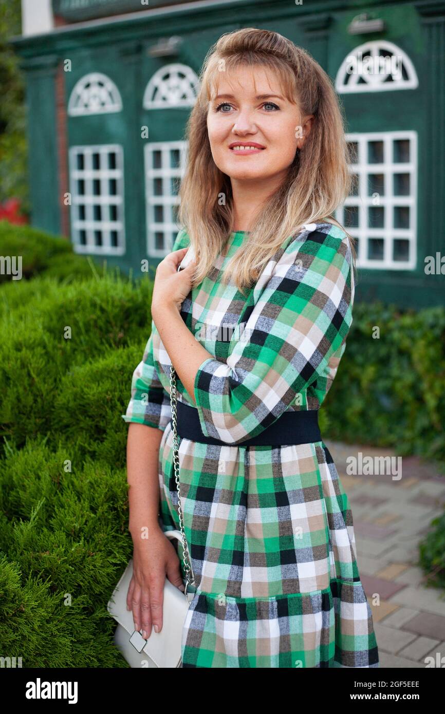 Happy woman in summer park in short dress Stock Photo - Alamy