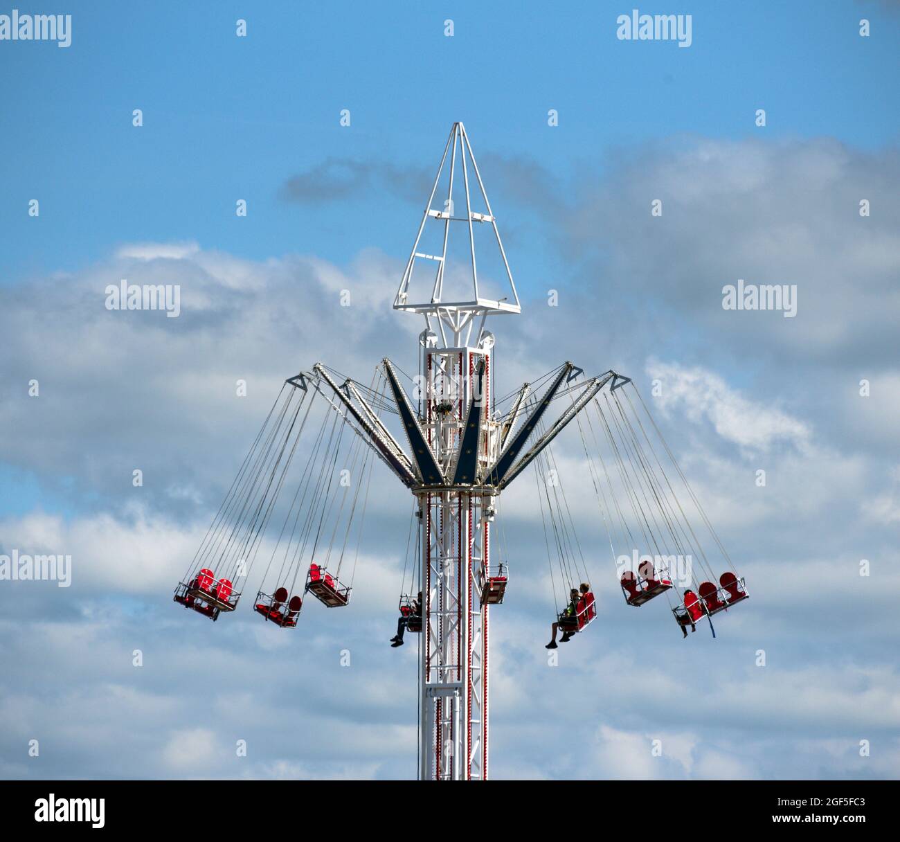 Riders on a high level funfair ride at Morecambe seaside resort ...