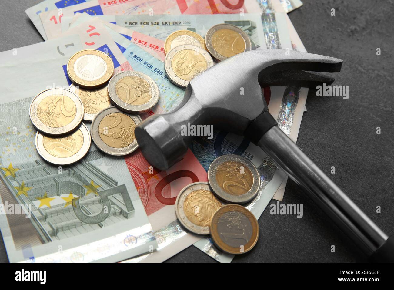 Money with hammer on grey background, close up Stock Photo - Alamy