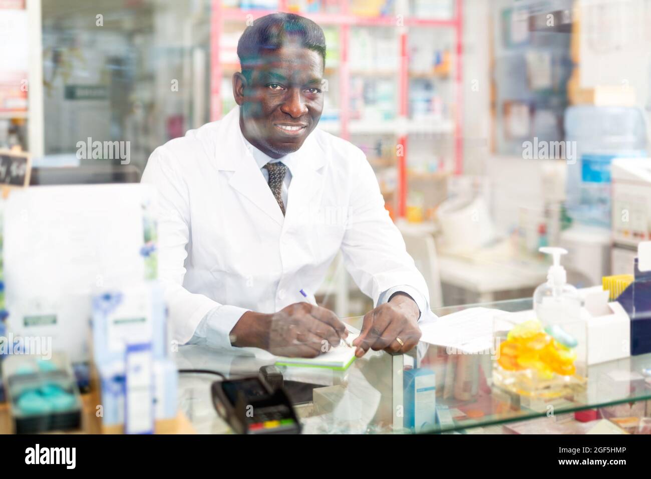African american male pharmacist makes important notes Stock Photo - Alamy
