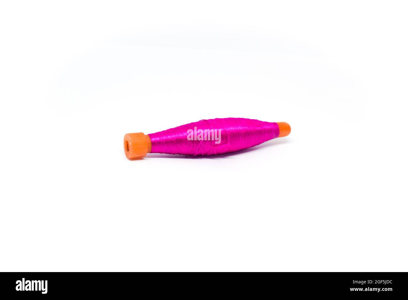 Thin roll of pink string isolated on a white background Stock Photo - Alamy