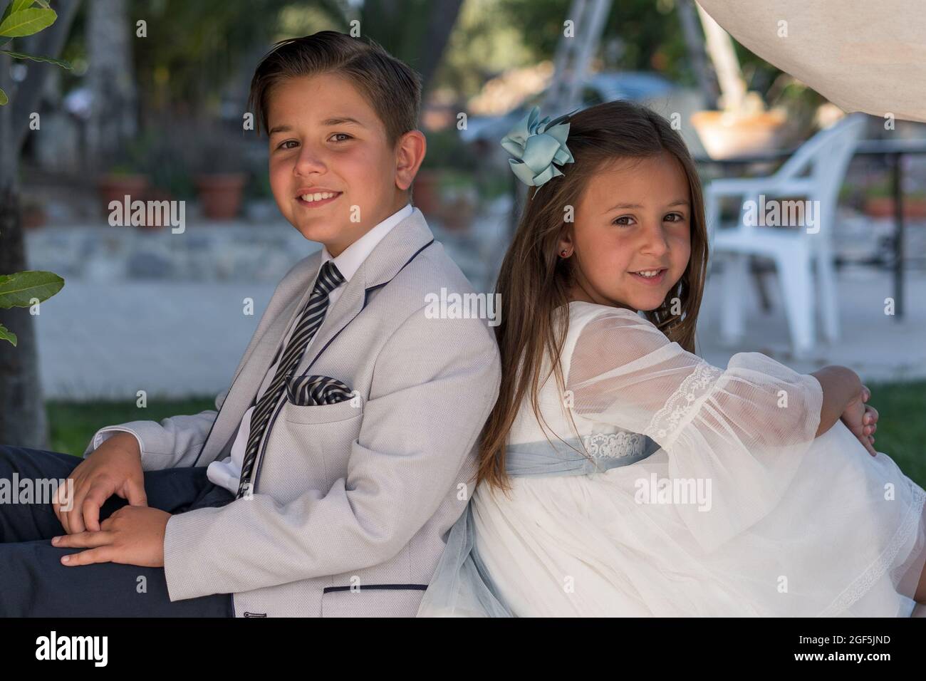 Pair of male and female siblings posing in formal outfits Stock Photo ...