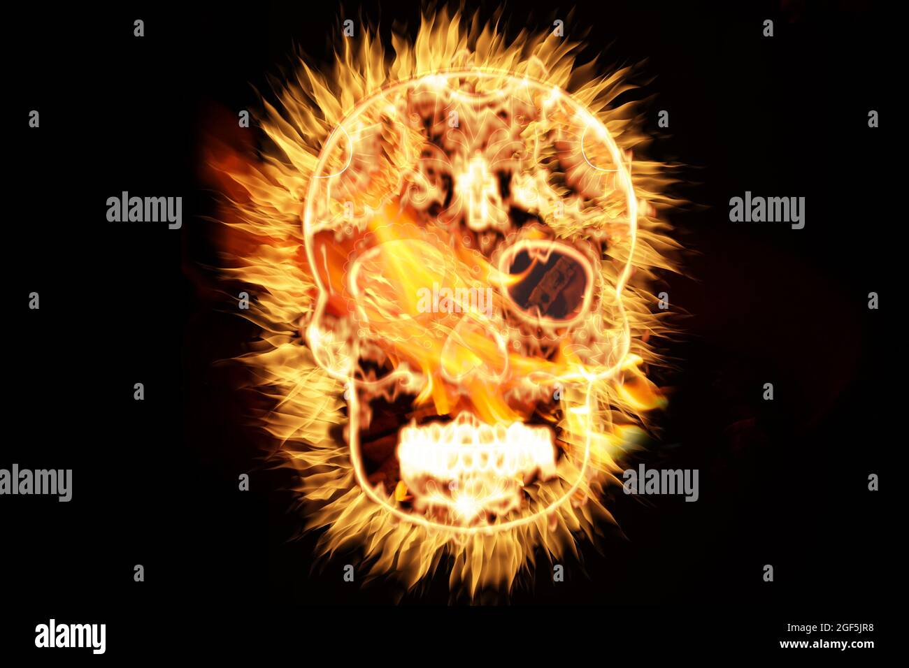 Traditional skull surrounded by flames and fire representing the ...
