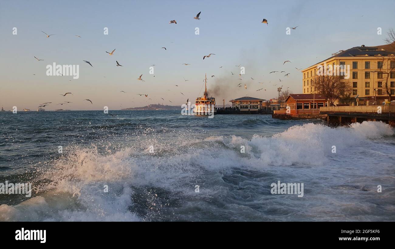 Wavy seascape with building on the background Stock Photo - Alamy