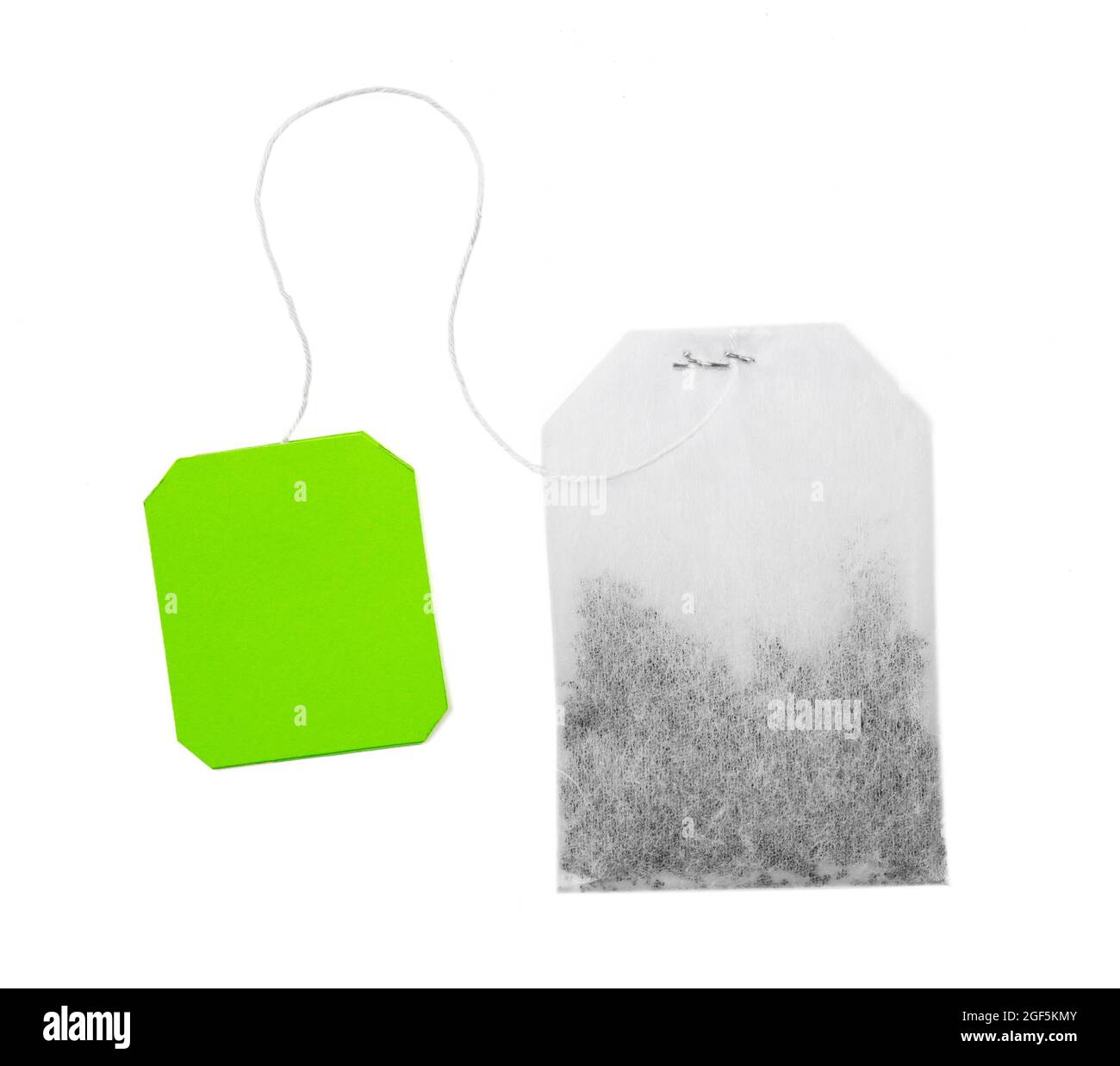 Teabag with green label isolated on white background Stock Photo - Alamy