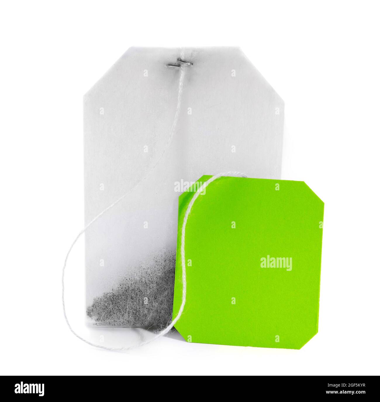 Teabag with green label isolated on white background Stock Photo - Alamy
