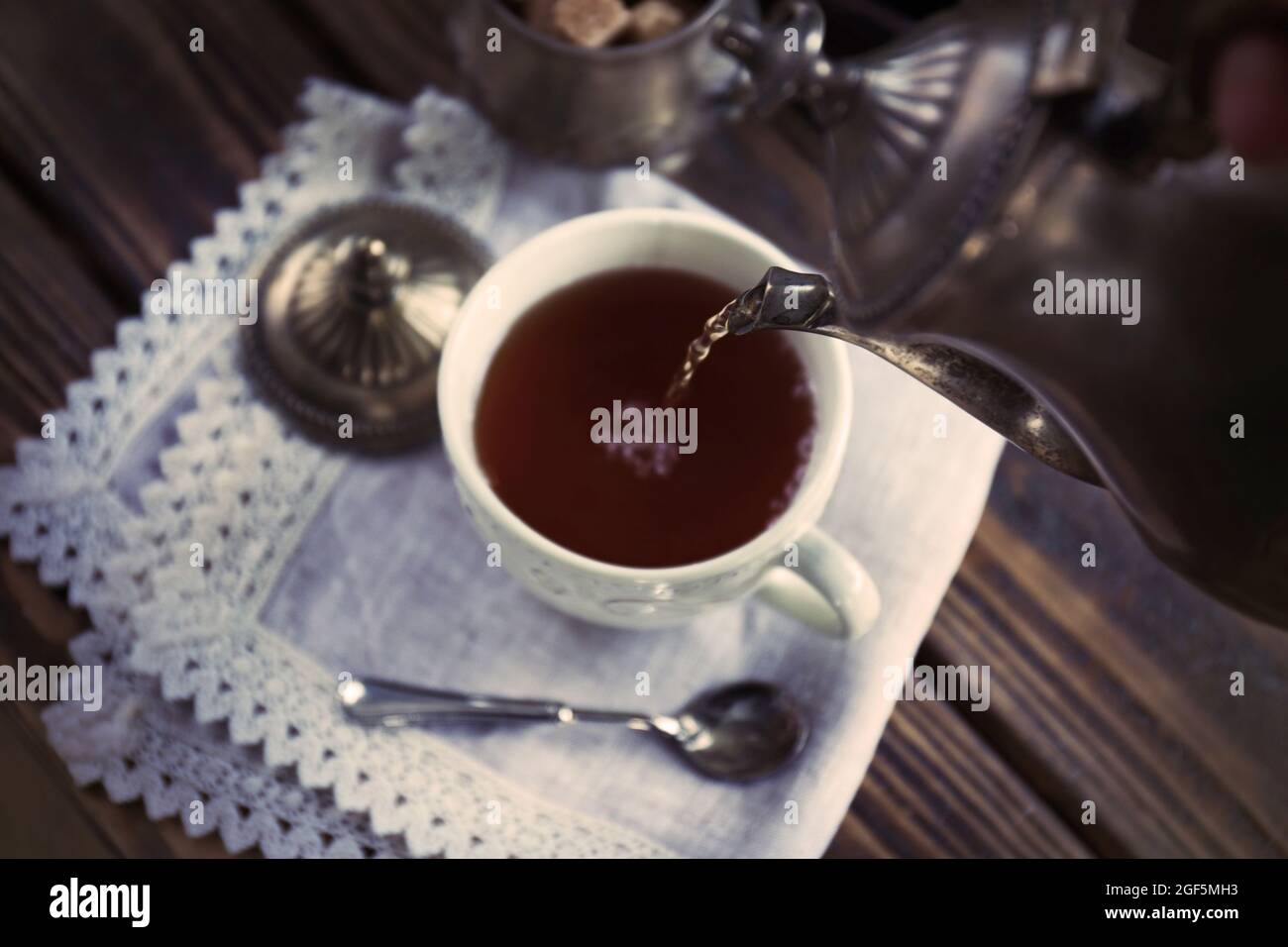 Tea pouring into the cup Stock Photo - Alamy
