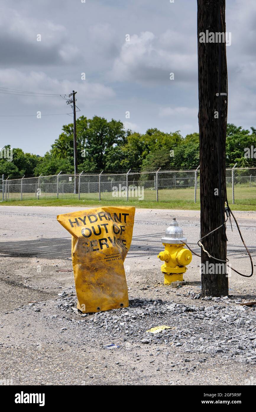 Old fire hydrant with a cover over it, stands next to a new fire ...