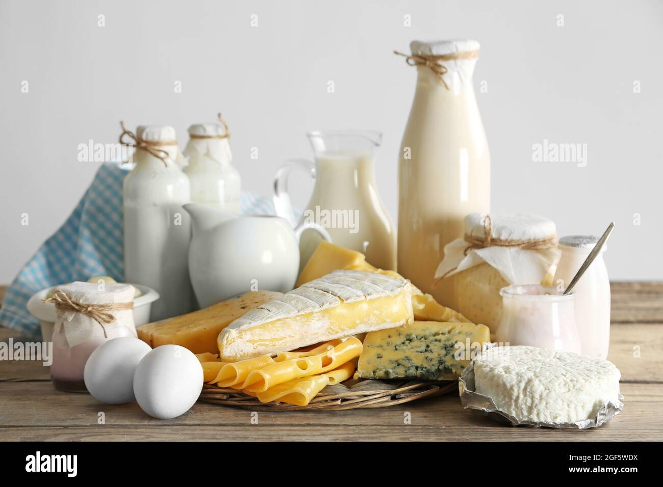 Set of fresh dairy products on wooden table, on white background Stock ...