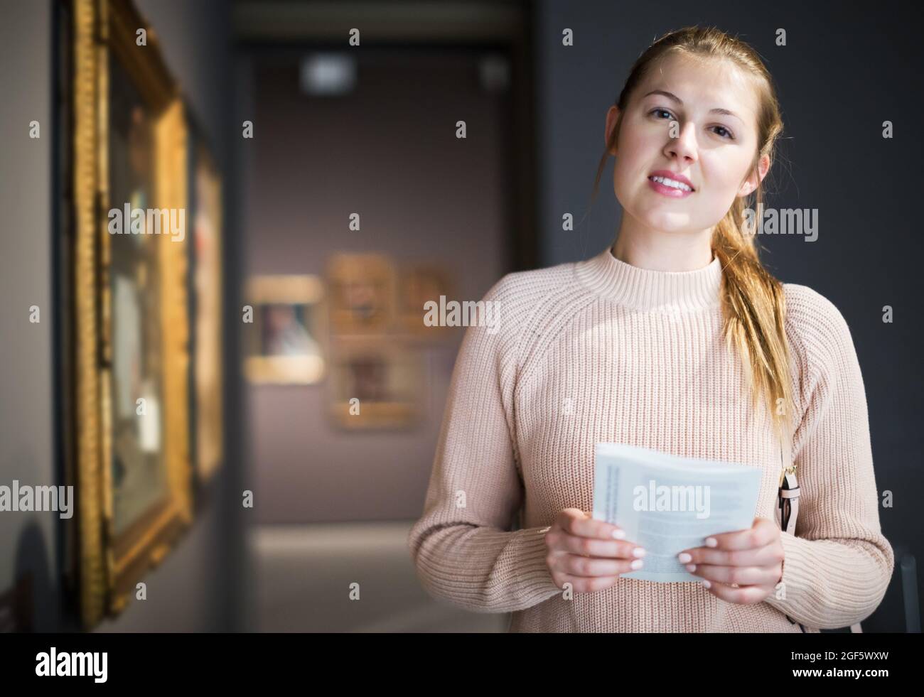 Woman at exhibition in museum Stock Photo - Alamy