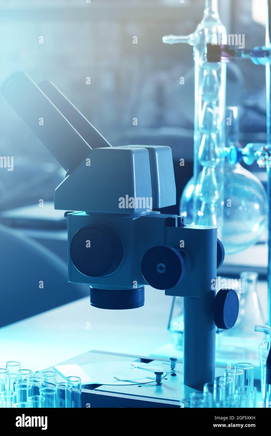 Microscope and different test tubes and flasks in laboratory Stock ...