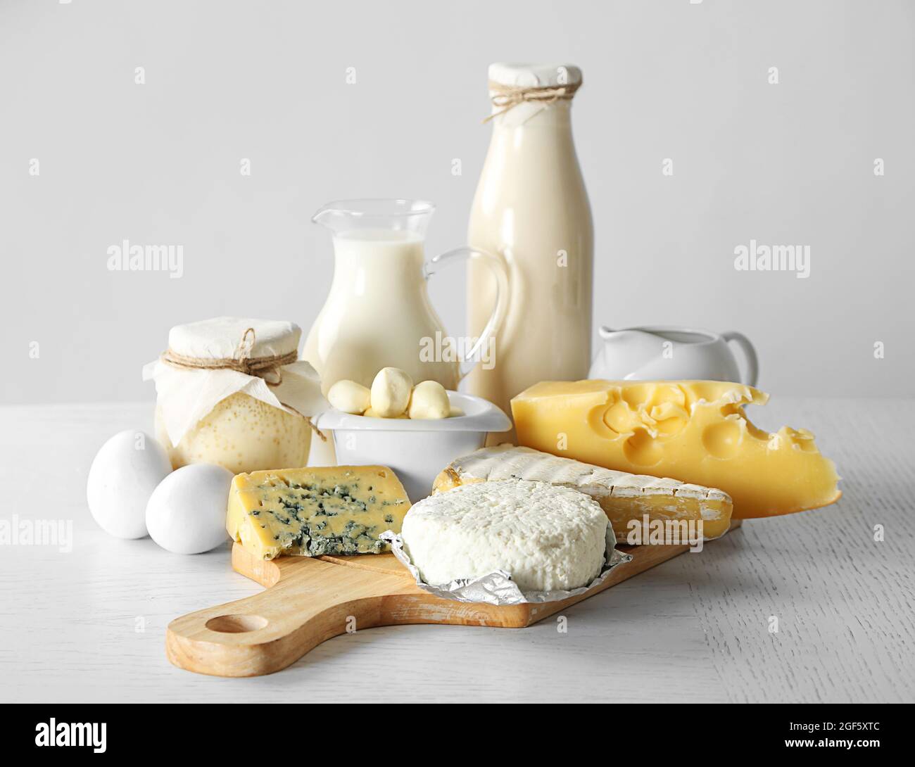 Set of fresh dairy products on wooden table, on white background Stock ...