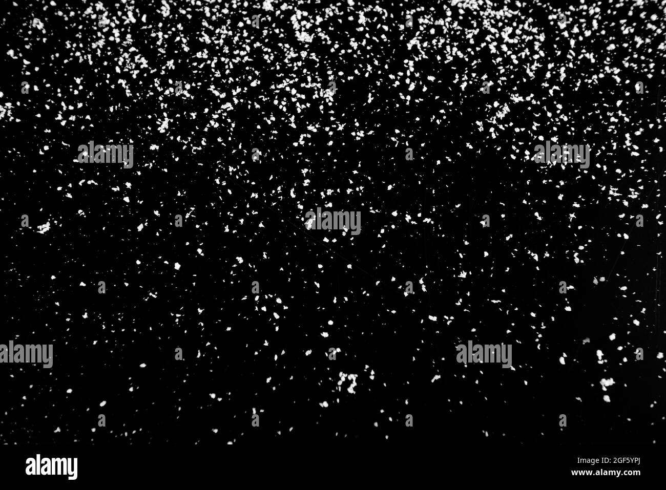 Snow flakes on dark background Stock Photo - Alamy