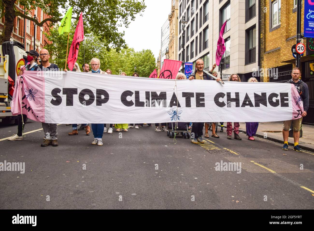 Demonstrators hold a 'Stop Climate Change' banner during the protest in ...