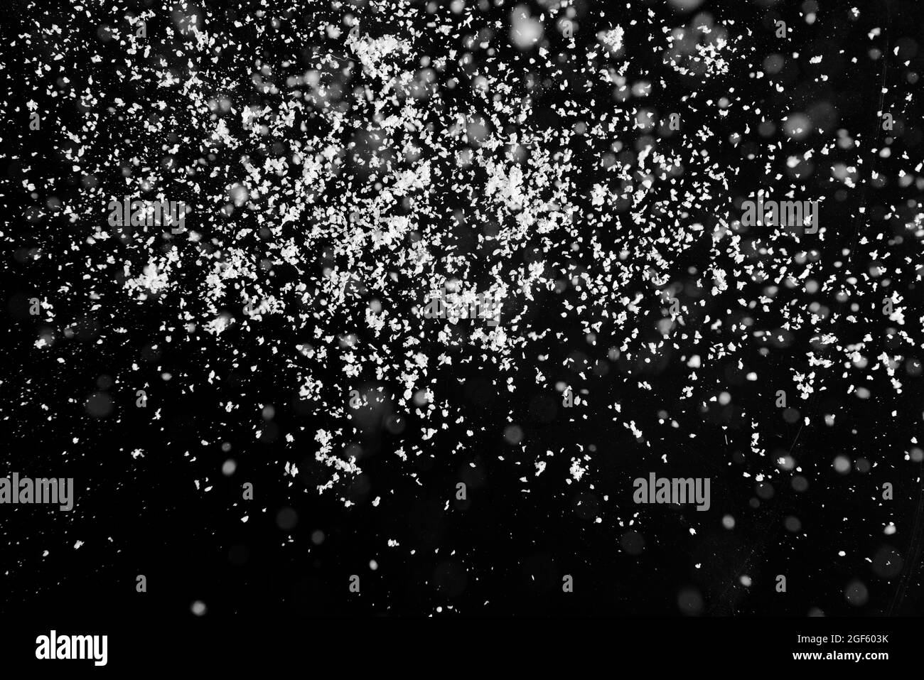 Snow flakes on dark background Stock Photo - Alamy