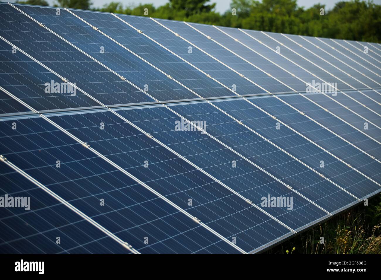 Solar panels fields on a green hills Stock Photo - Alamy