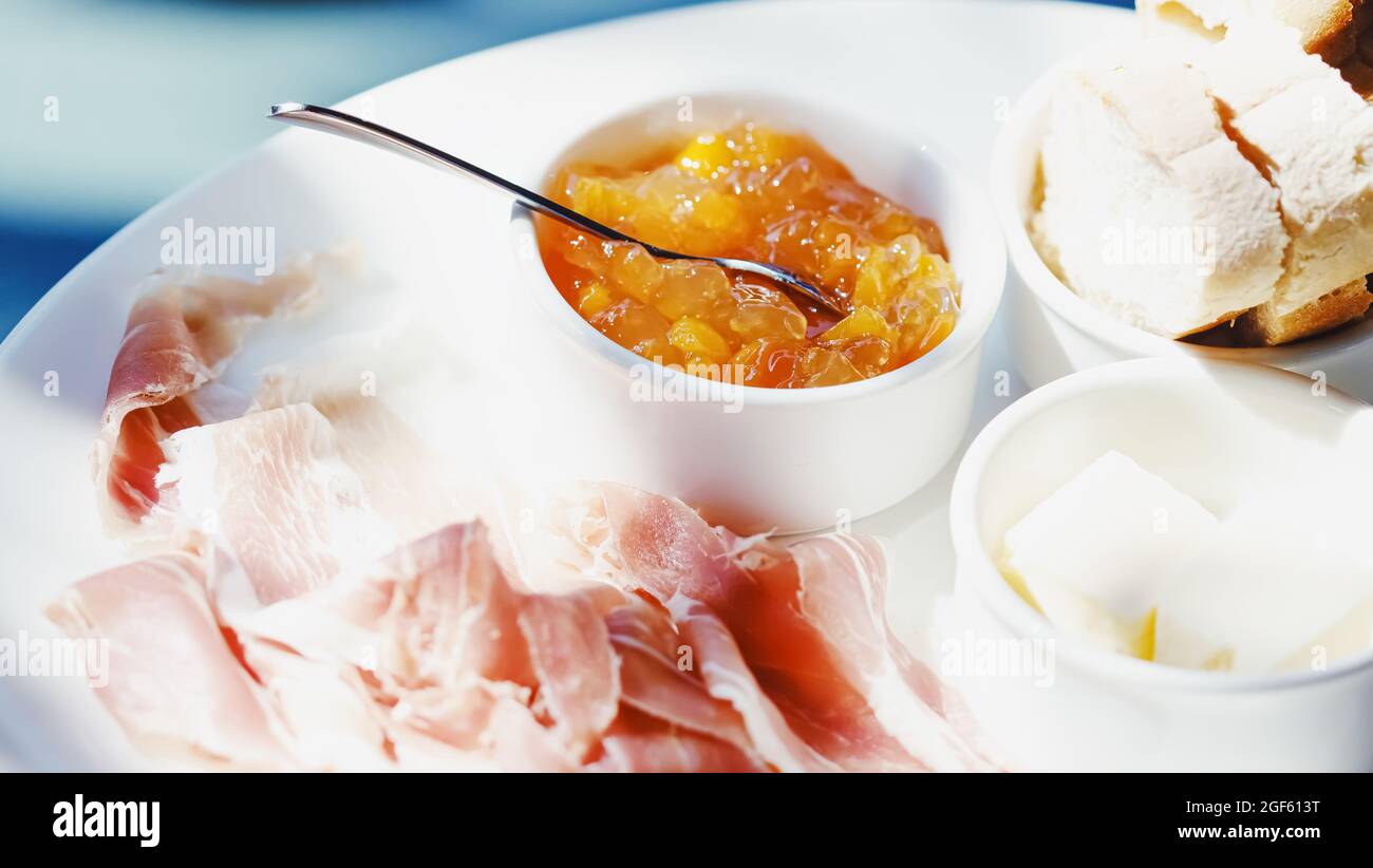 Breakfast outdoors in summer, ham, jam, butter and ham Stock Photo - Alamy